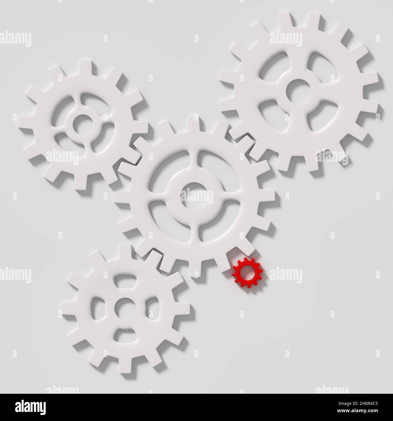 White connecting gear cogs of various sizes and single red cog isolated ...