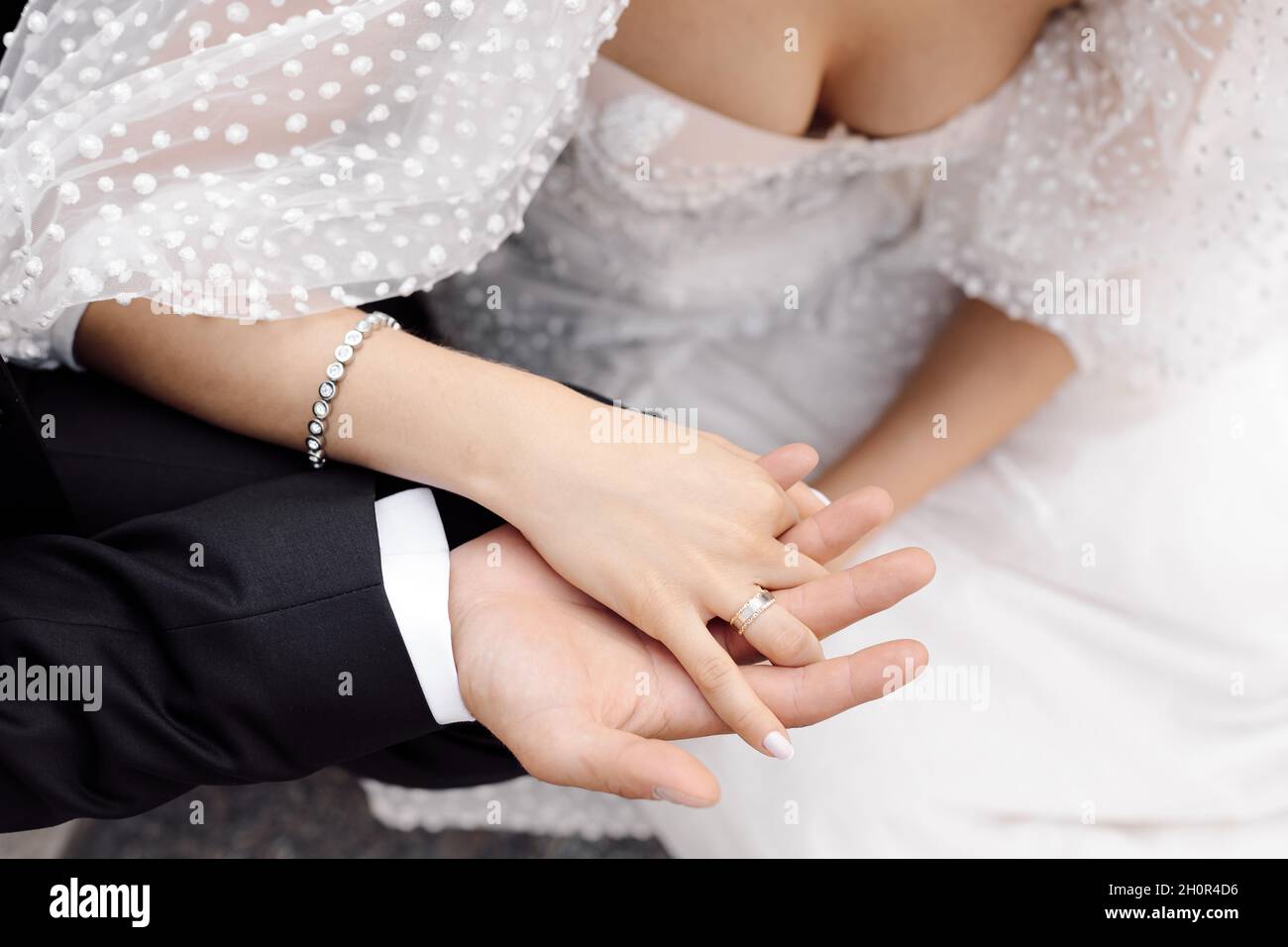 young man, groom holds in his hand hand of his woman bride, bride in ...
