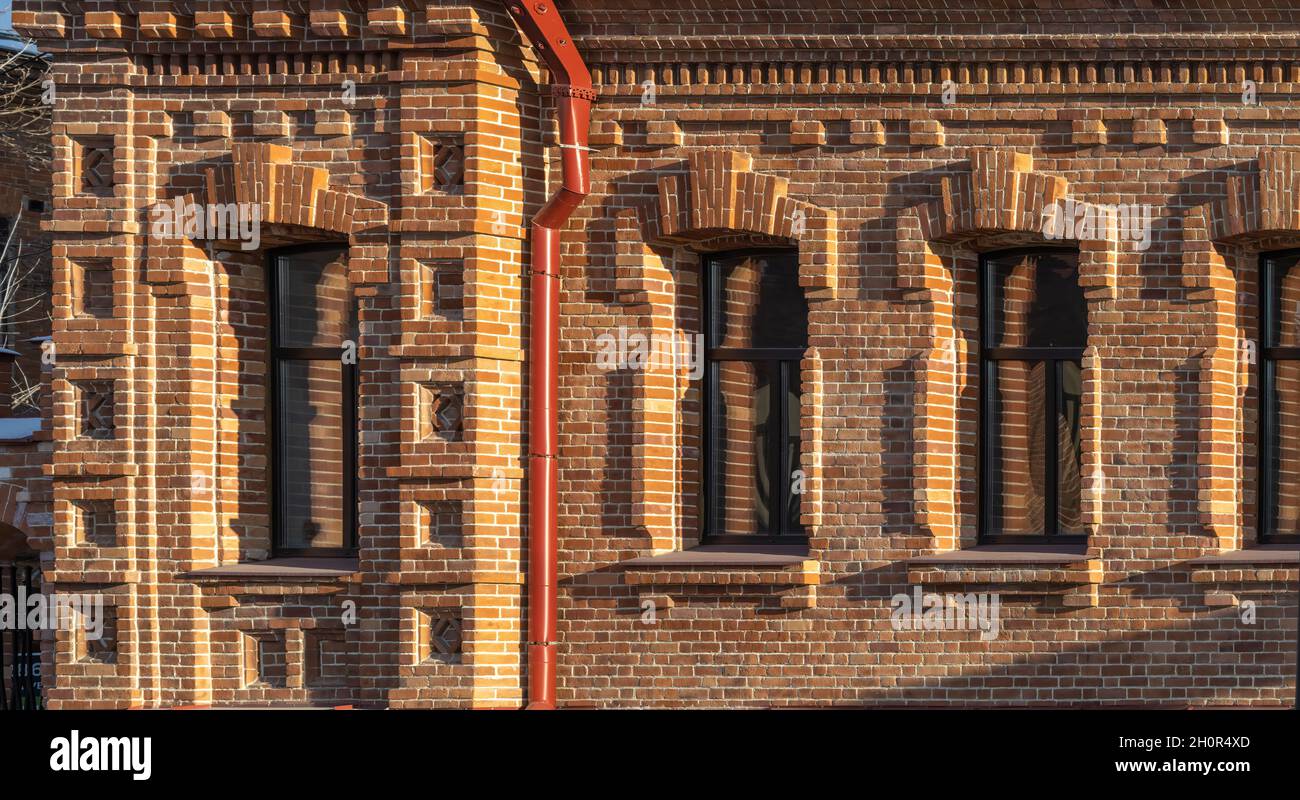 Three windows of the old mansion 19 century with brown bricks wall ...