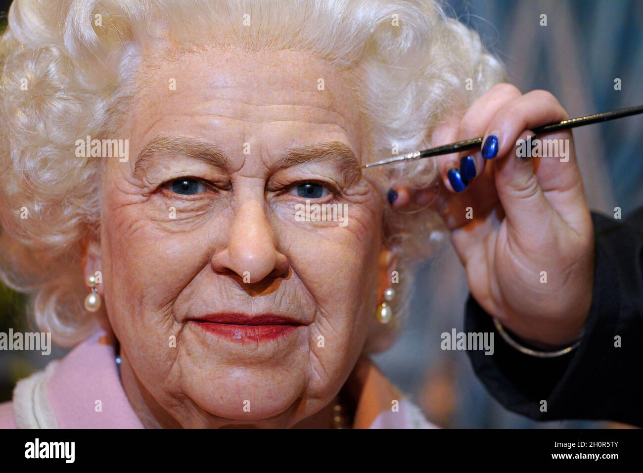 Emma Meehan puts the finishing touches to a wax figure of Queen ...