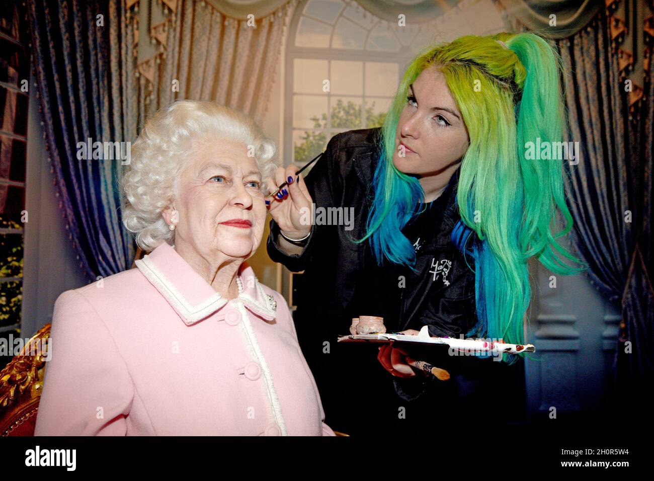 Emma Meehan puts the finishing touches to a wax figure of Queen ...