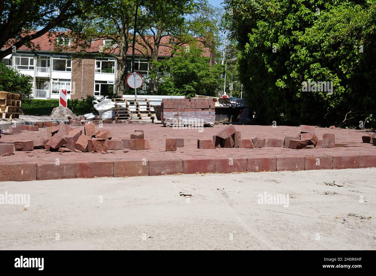 Construction of a cobblestone street. Pile of cobblestones with sand ...