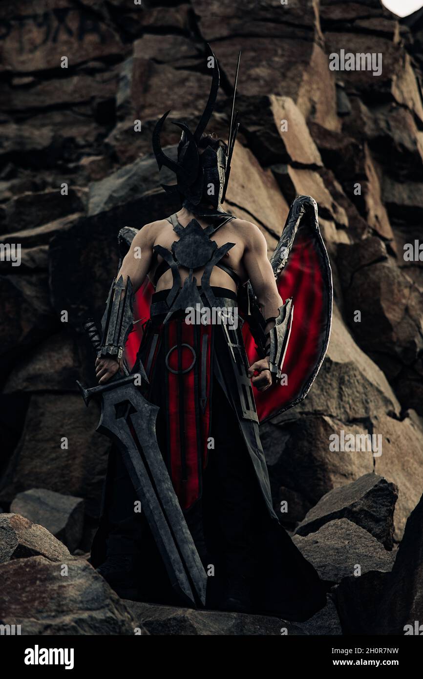 Man in image of daemon of death with wings behind his back stands with ...