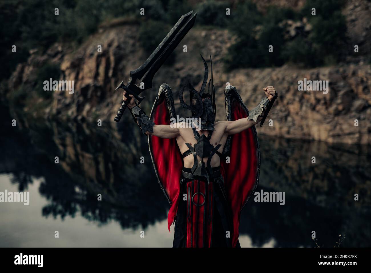 Man in image of daemon of death with wings behind his back stands with ...
