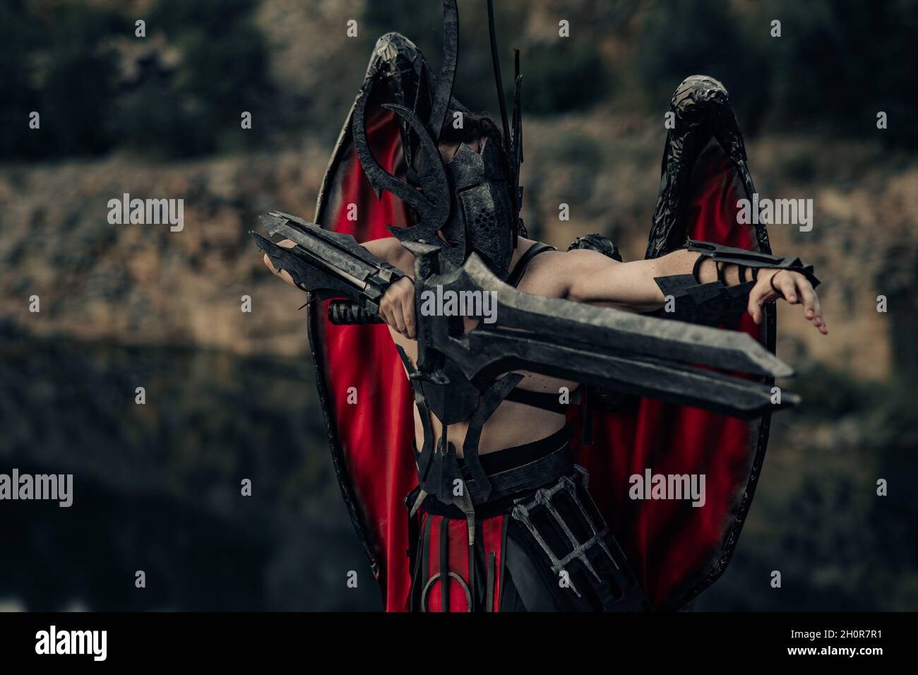 Man in image of daemon of death with wings behind his back stands on ...