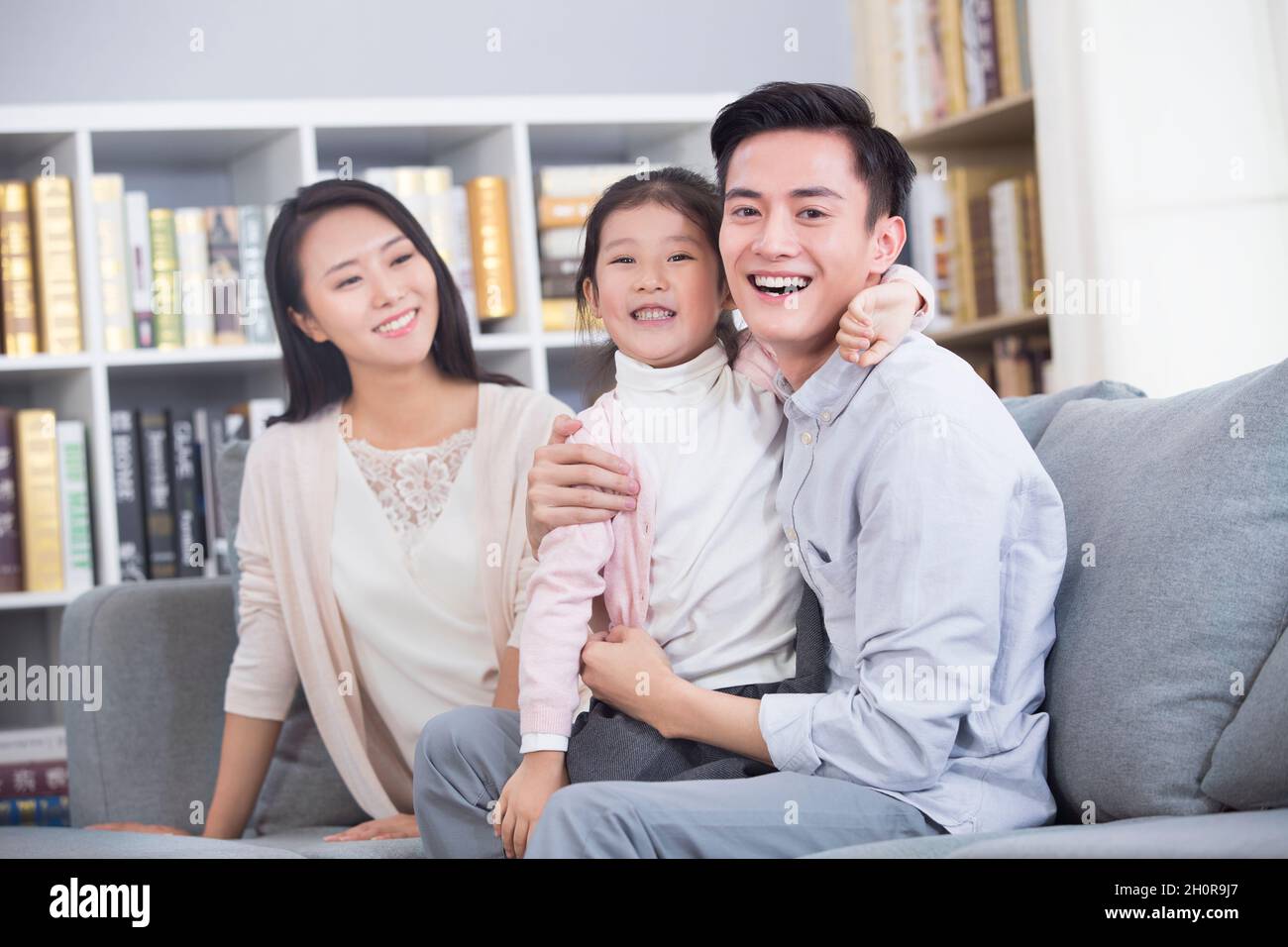 A happy family of three Stock Photo - Alamy