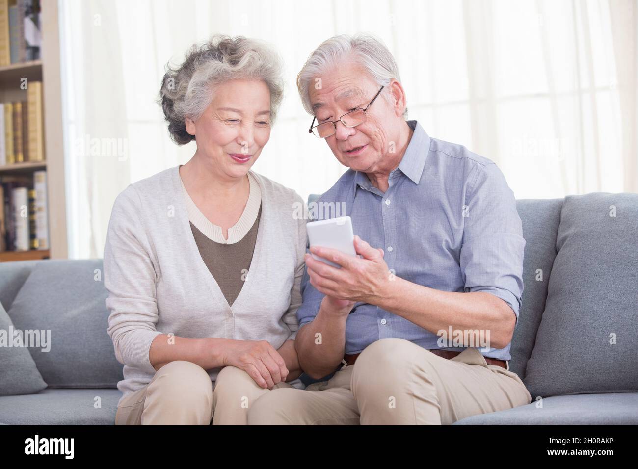 Old people in the East using a mobile phone Stock Photo - Alamy