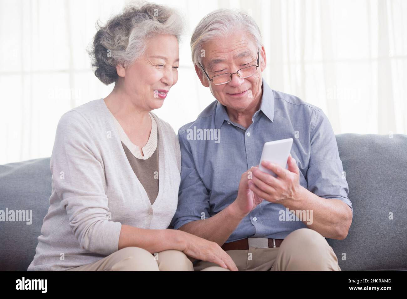 Old people in the East using a mobile phone Stock Photo - Alamy