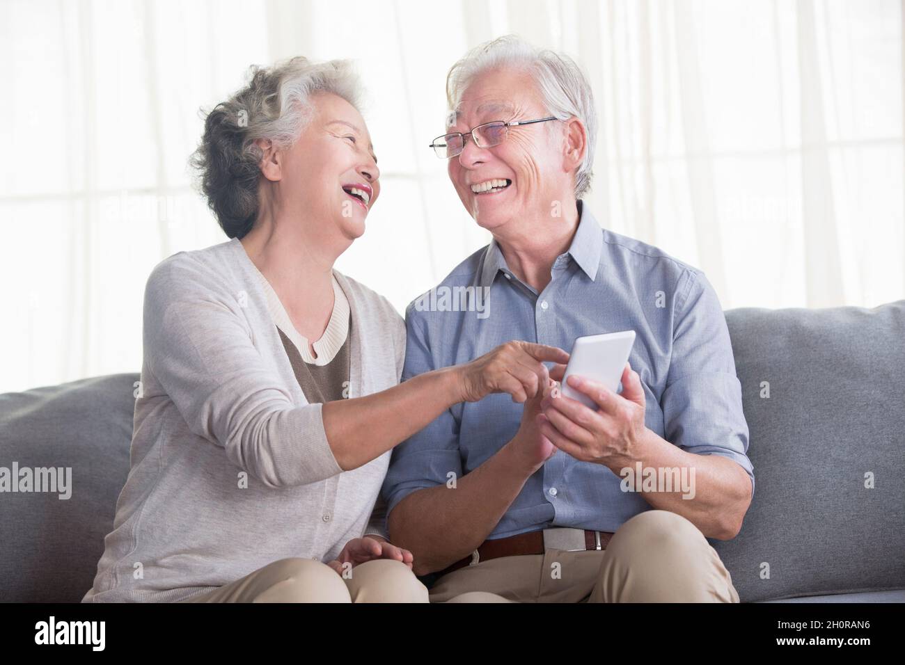 Old people in the East using a mobile phone Stock Photo - Alamy
