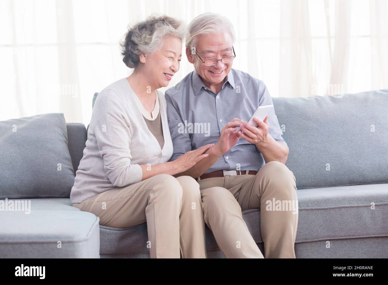 Old people in the East using a mobile phone Stock Photo - Alamy