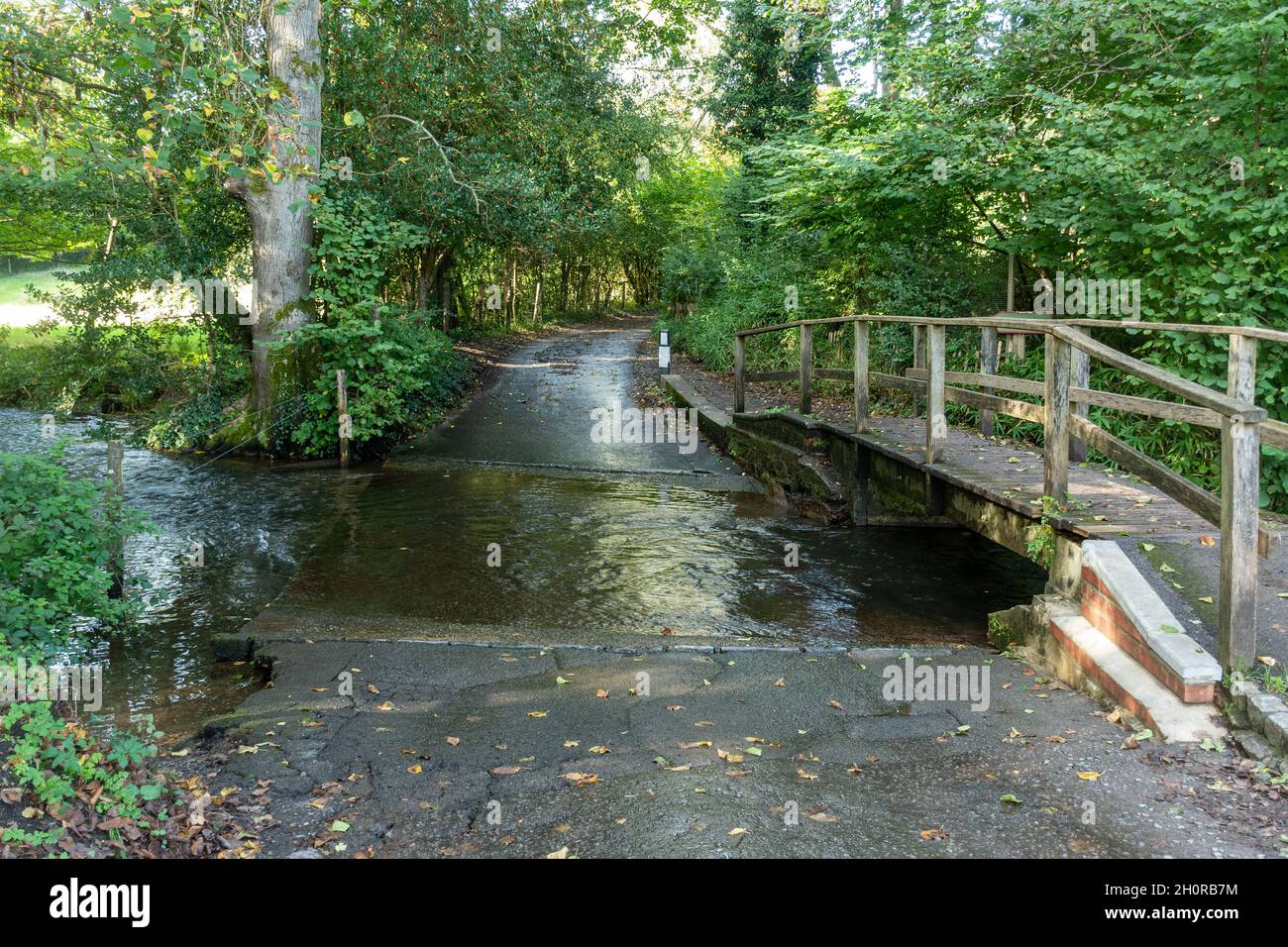 Ford in Shere village in Surrey, England, UK, with a footbridge over ...