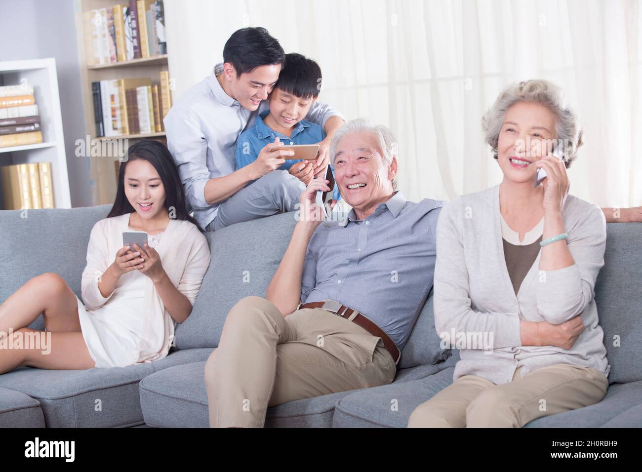 The happy family using their phones Stock Photo - Alamy