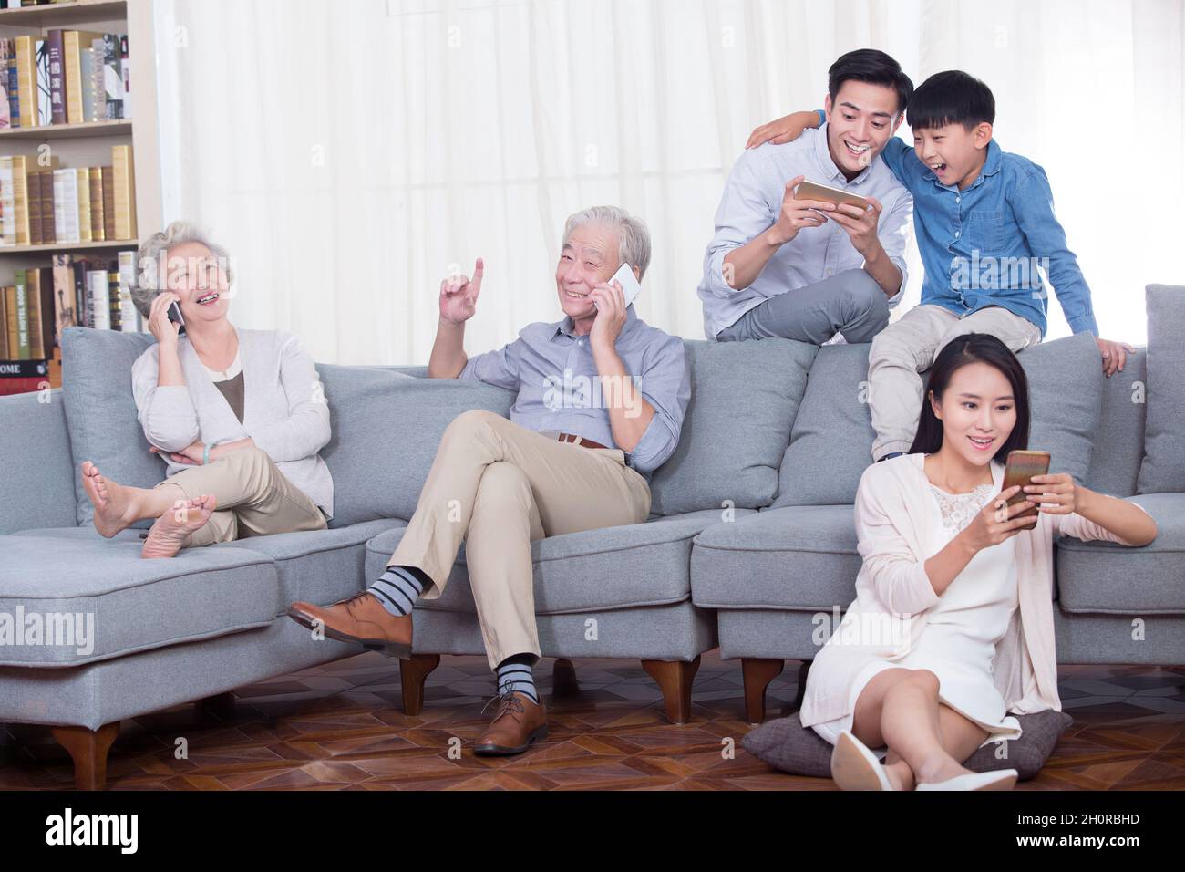 The happy family using their phones Stock Photo - Alamy