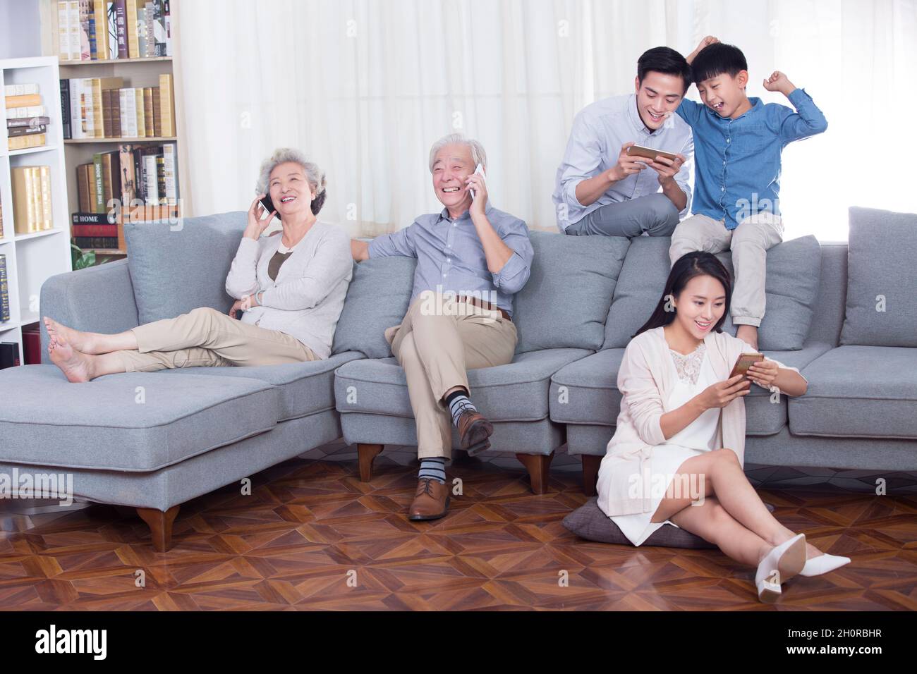 The happy family using their phones Stock Photo - Alamy