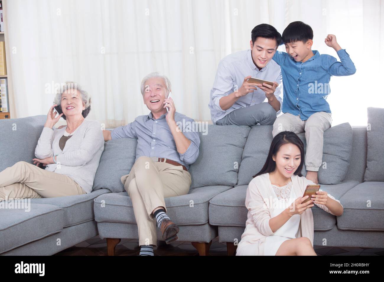 The happy family using their phones Stock Photo - Alamy
