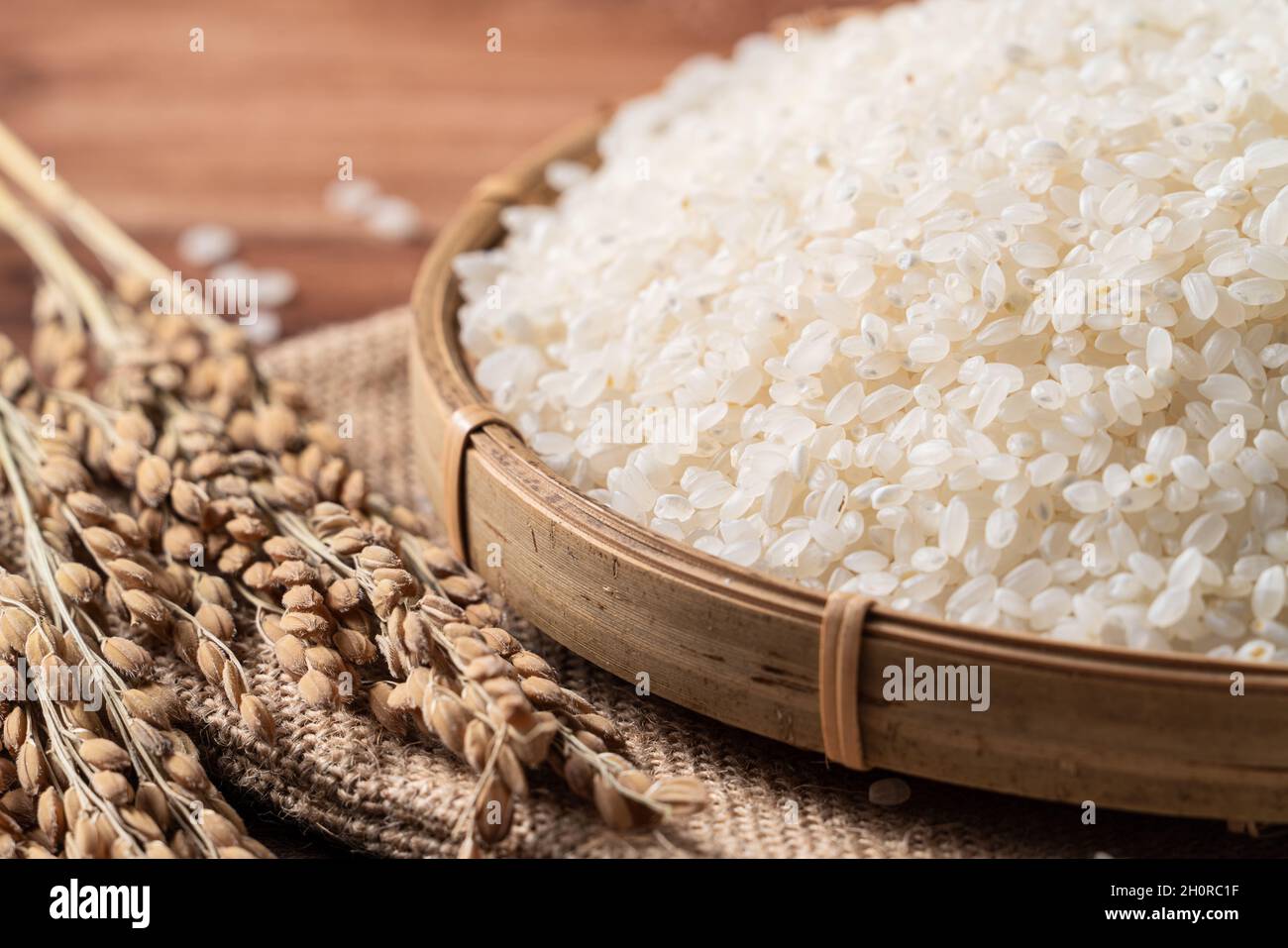 Raw white polished milled edible rice on wooden table background in a ...