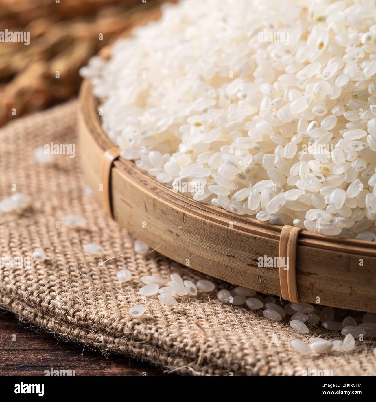 Raw white polished milled edible rice on wooden table background in a ...