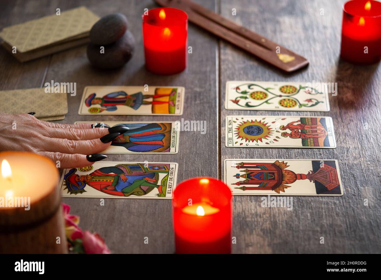 Fortune teller reading a future by tarot cards on rustic table Stock ...