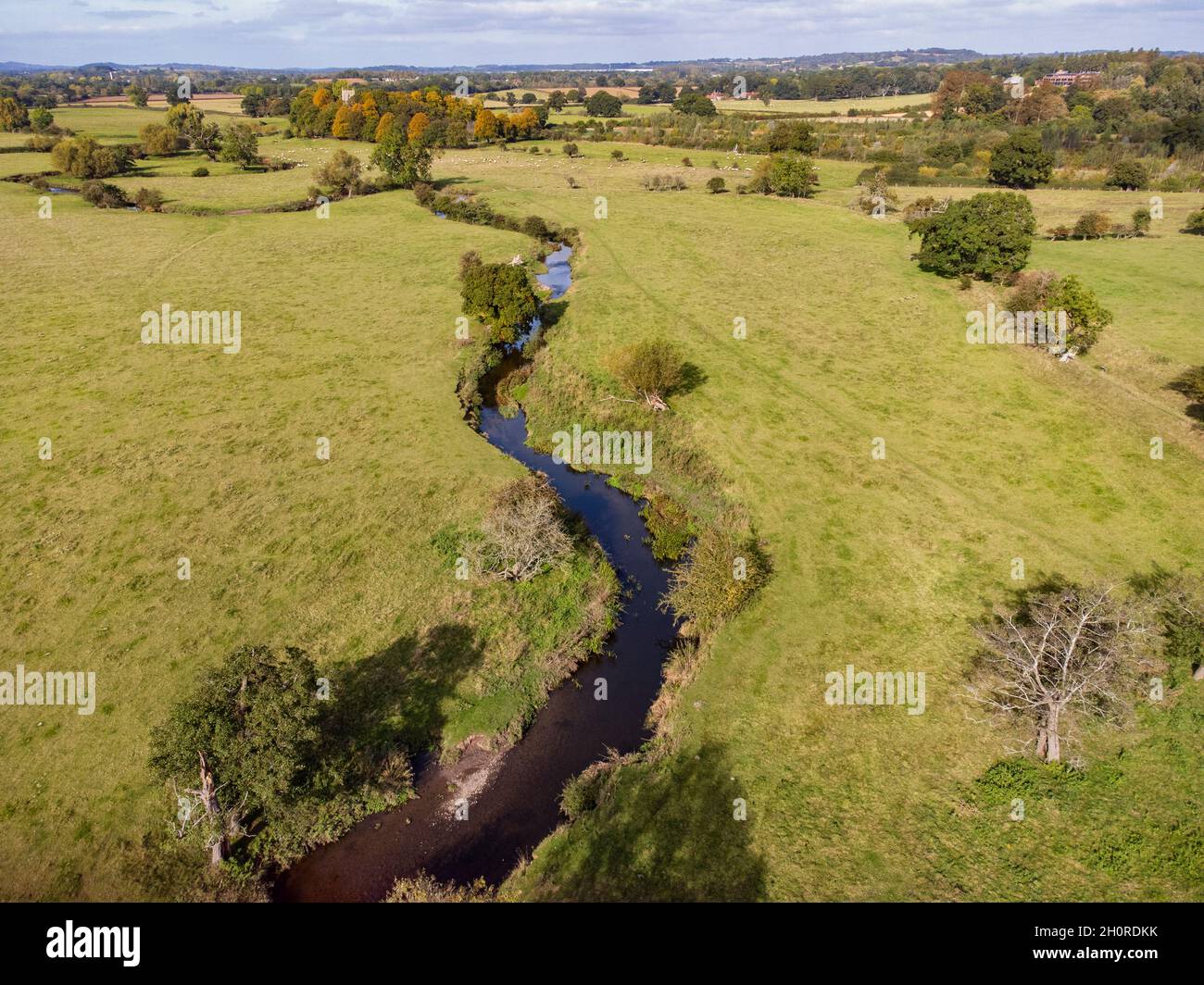 An aerial view of the small river Arrow running through farmland in ...