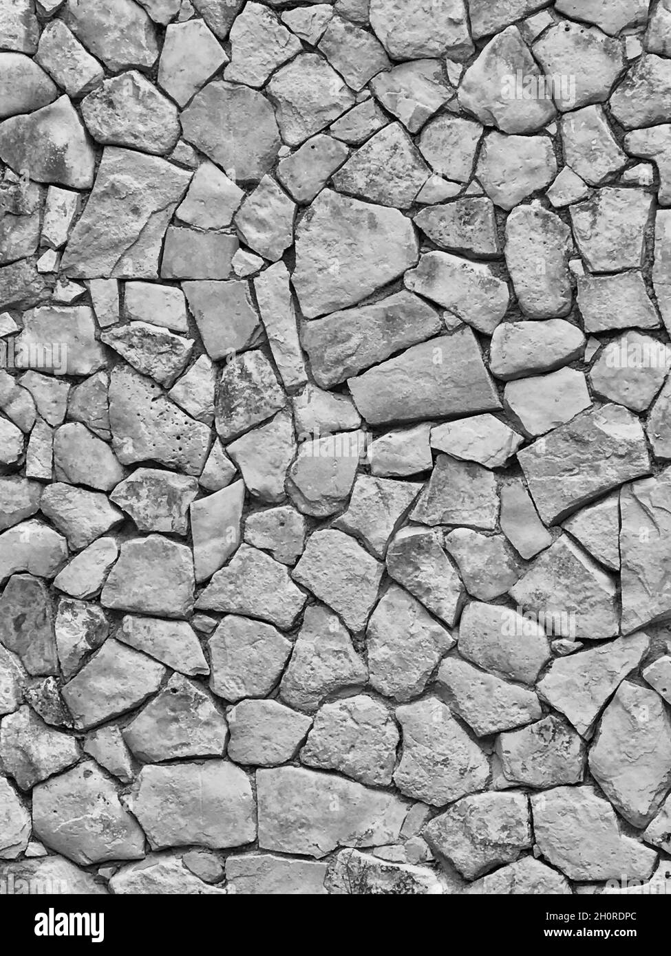 Vertical grayscale shot of a stone wall texture for backgrounds Stock ...
