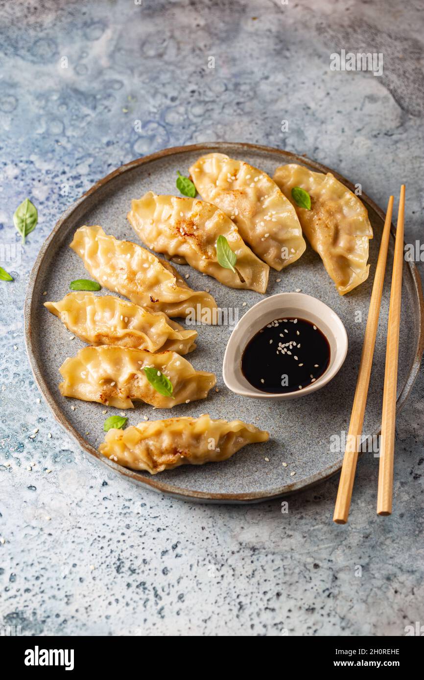 Asian dumplings with soy sauce, sesame seeds and microgreens ...