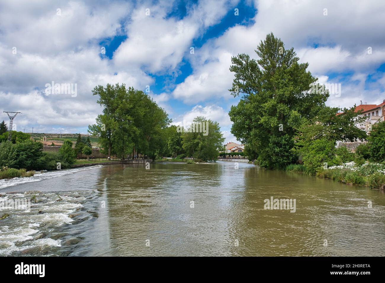 Beautiful scene of a water lake and trees under sunny cloudy sky in ...