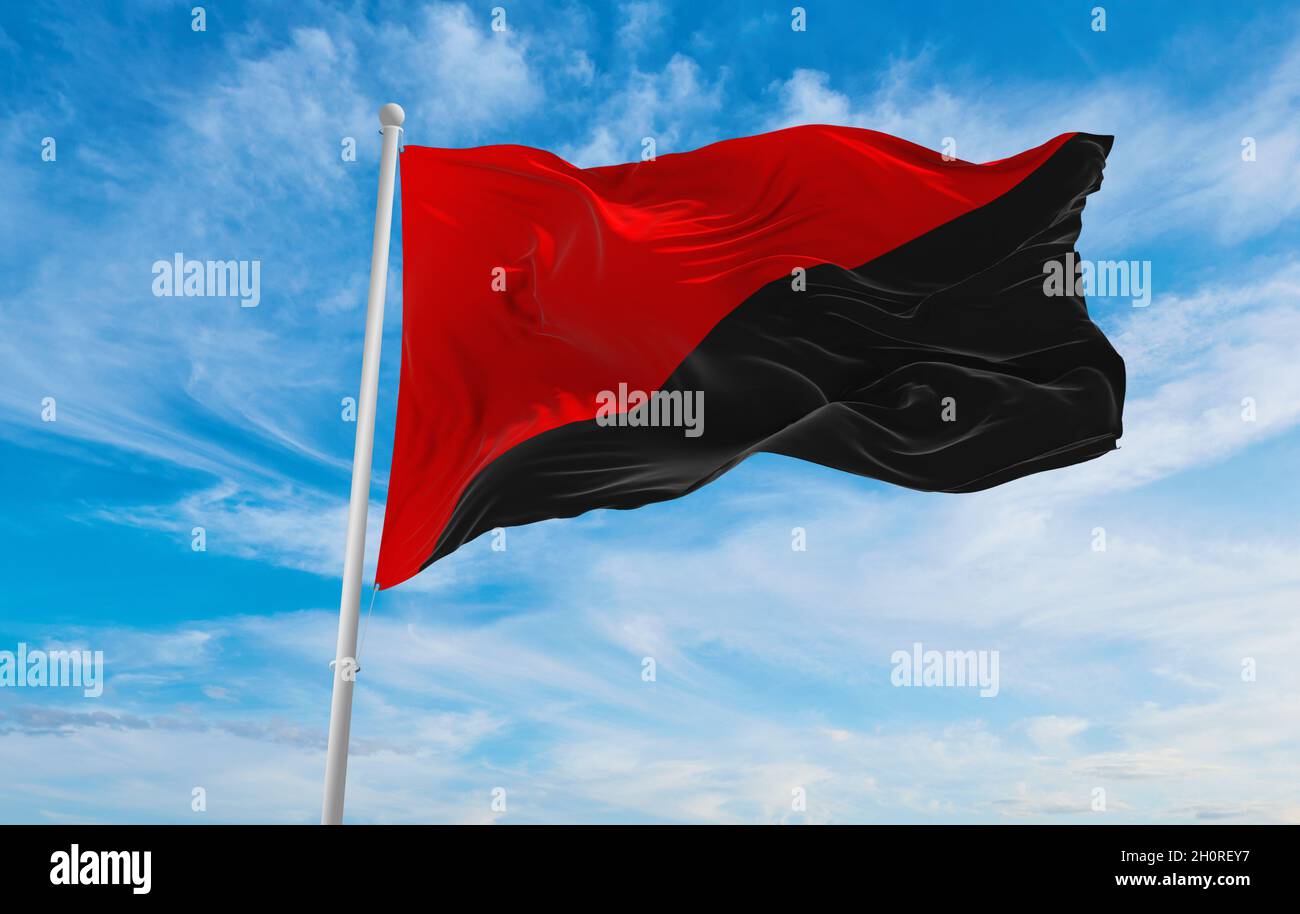 flag of Anarchism at cloudy sky background on sunset, panoramic view ...