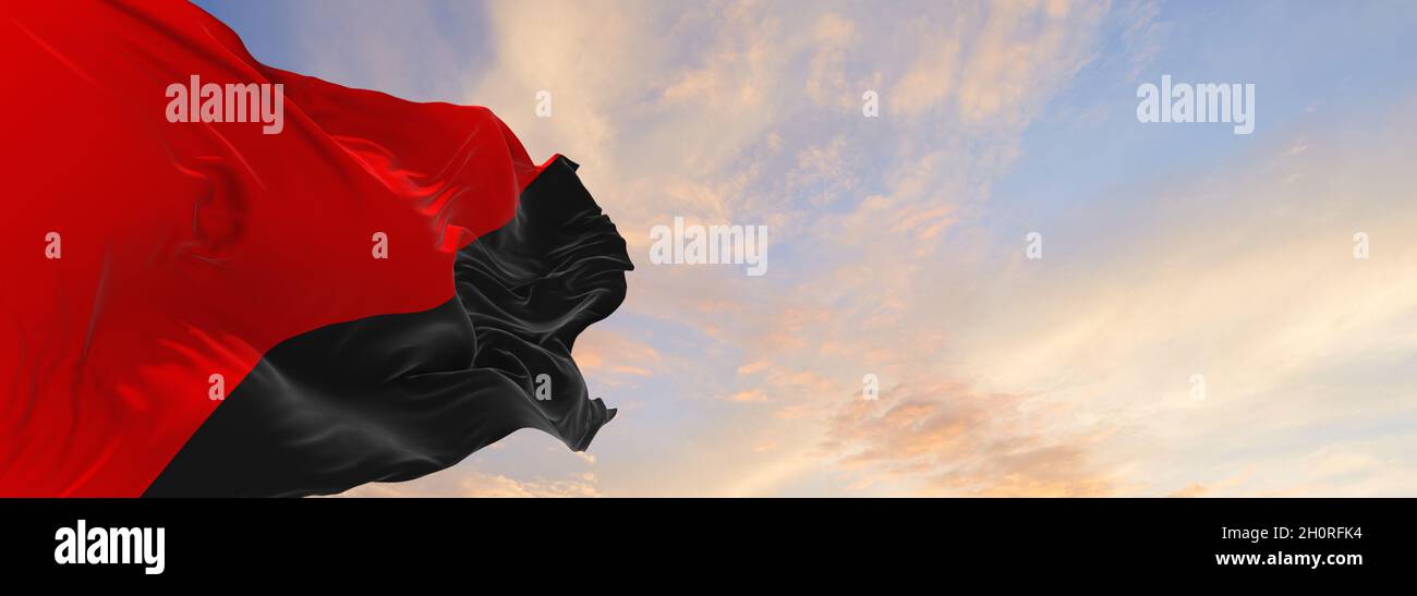 flag of Anarchism at cloudy sky background on sunset, panoramic view ...
