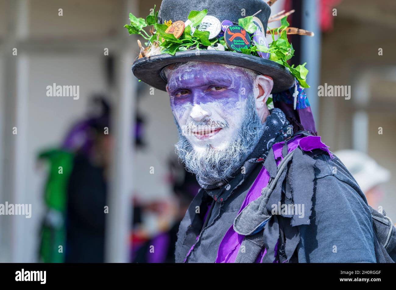 portrait of white and purple painted face of a morris dancer, head ...
