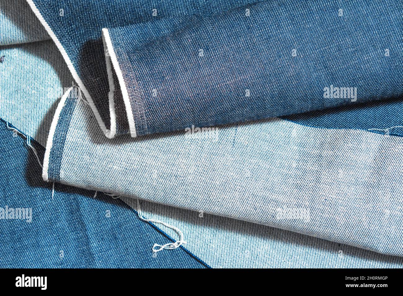 Denim blue jeans texture. Folded jeans top view. Denim jeans background ...