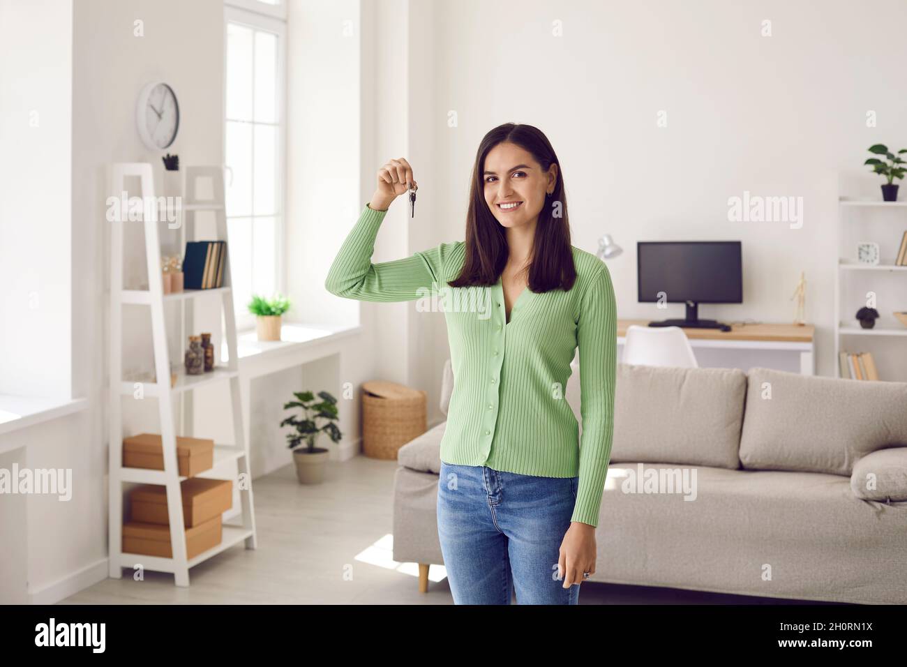 Portrait of happy successful young woman who is happy to move to a new ...