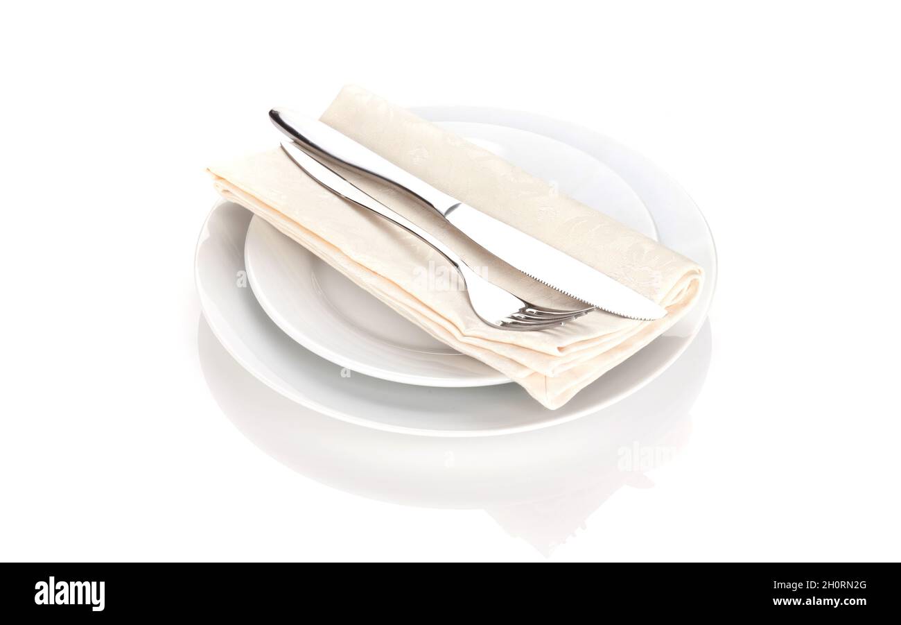 Silverware over plates. Isolated on white background. Set of fork ...
