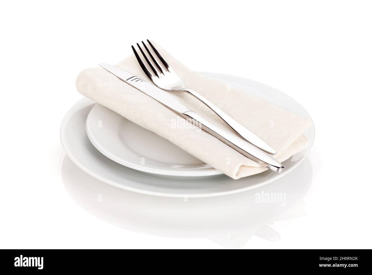 Silverware over plates. Isolated on white background. Set of fork ...