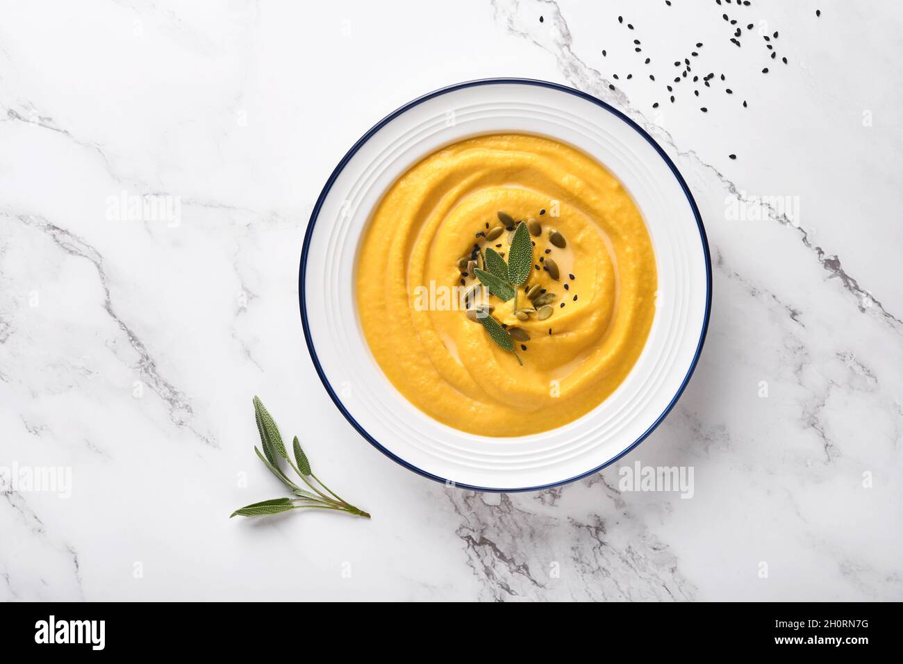 Pumpkin traditional soup with creamy silky texture with sage leaves and ...