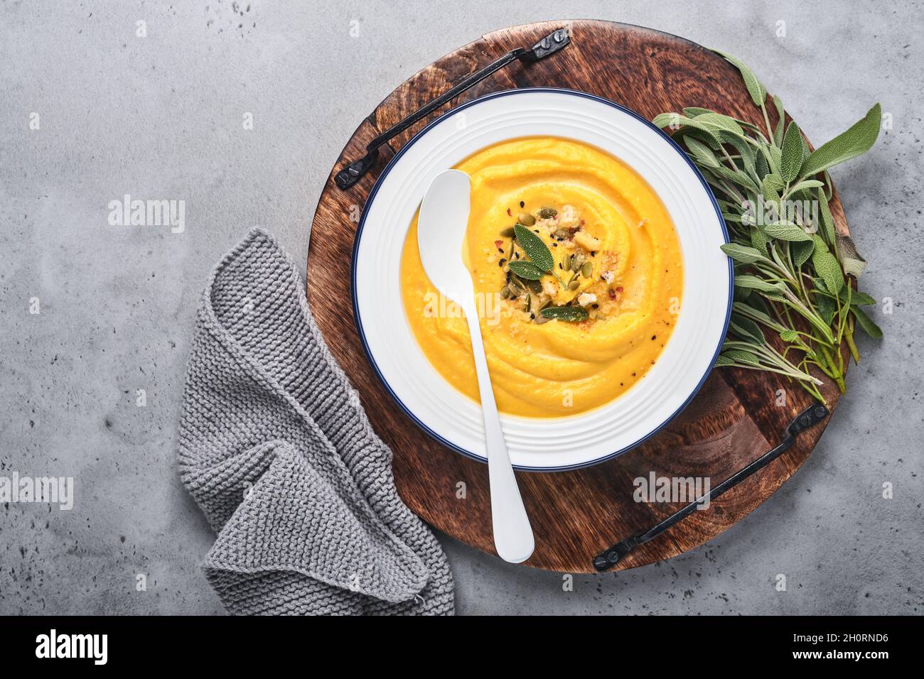 Pumpkin traditional soup with creamy silky texture with sage leaves and ...