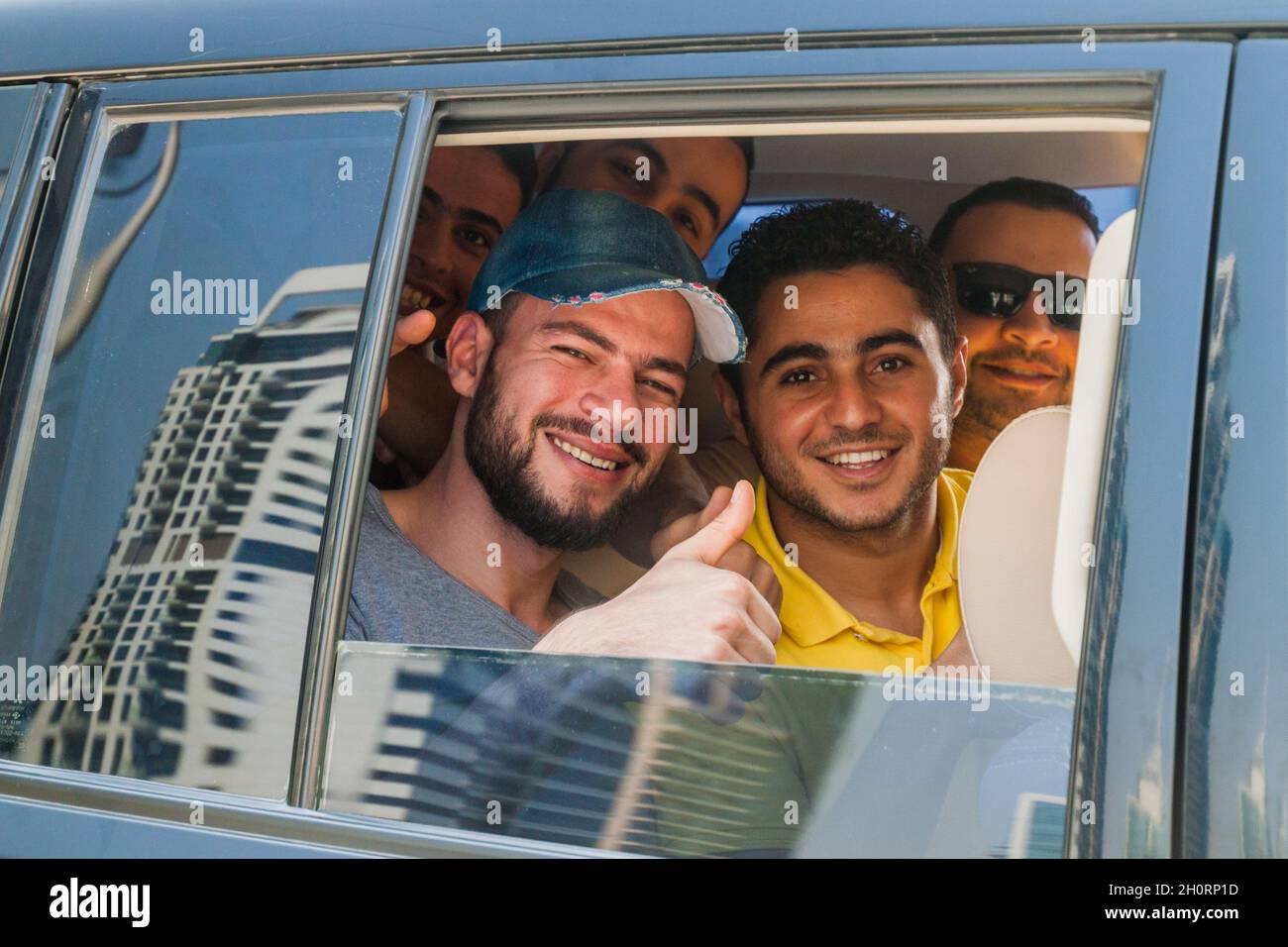 DUBAI, UAE - OCTOBER 21, 2016: Local young men look from a car in Dubai ...