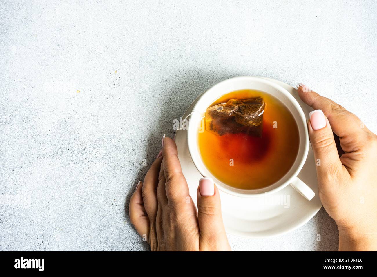 Overhead view of a woman enjoying a cup of tea Stock Photo - Alamy