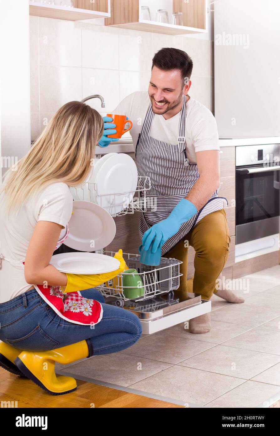 Man loading dishwasher woman hi-res stock photography and images - Alamy