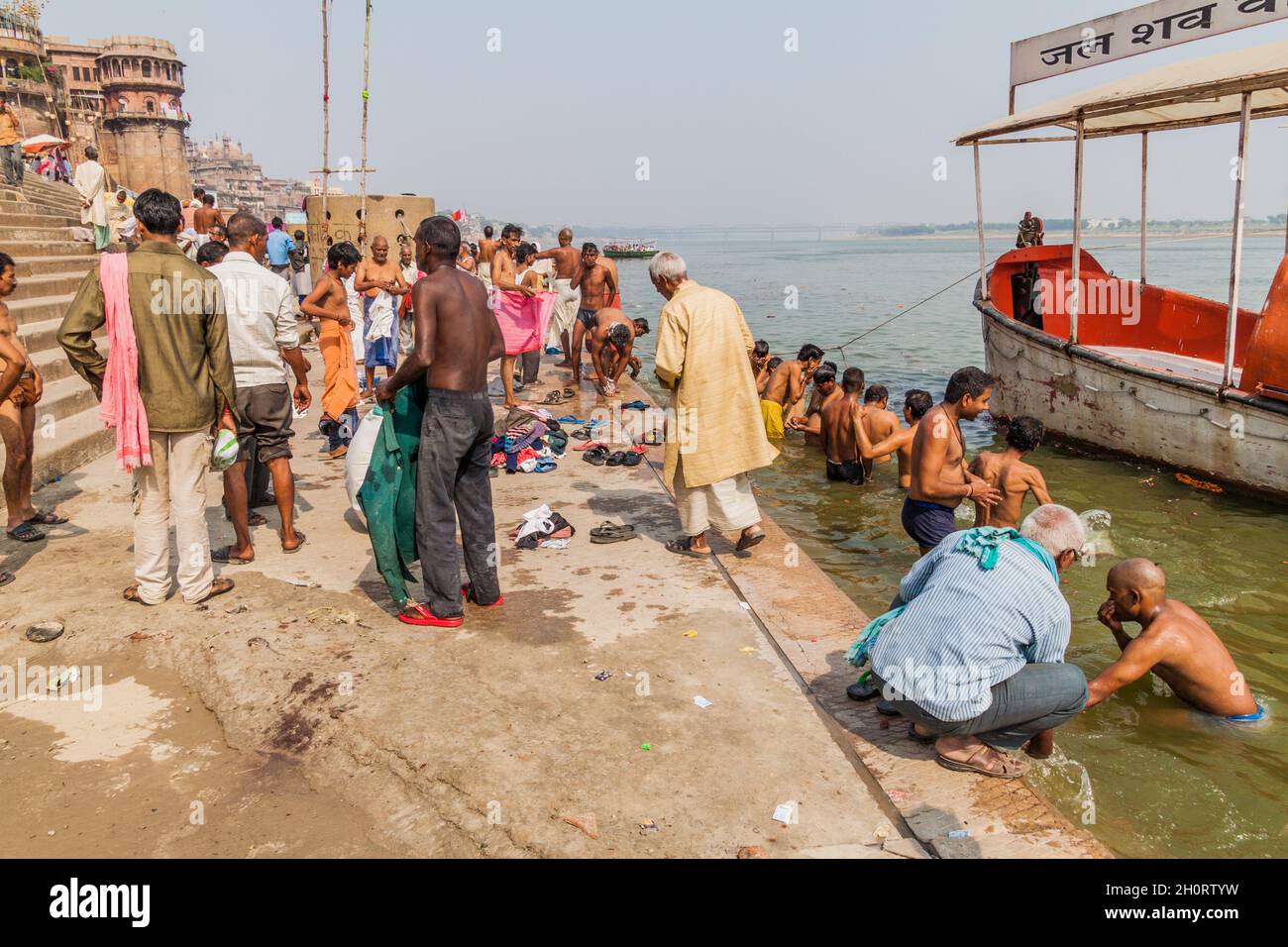 VARANASI, INDIA - OCTOBER 25, 2016: Local people wash themself in ...