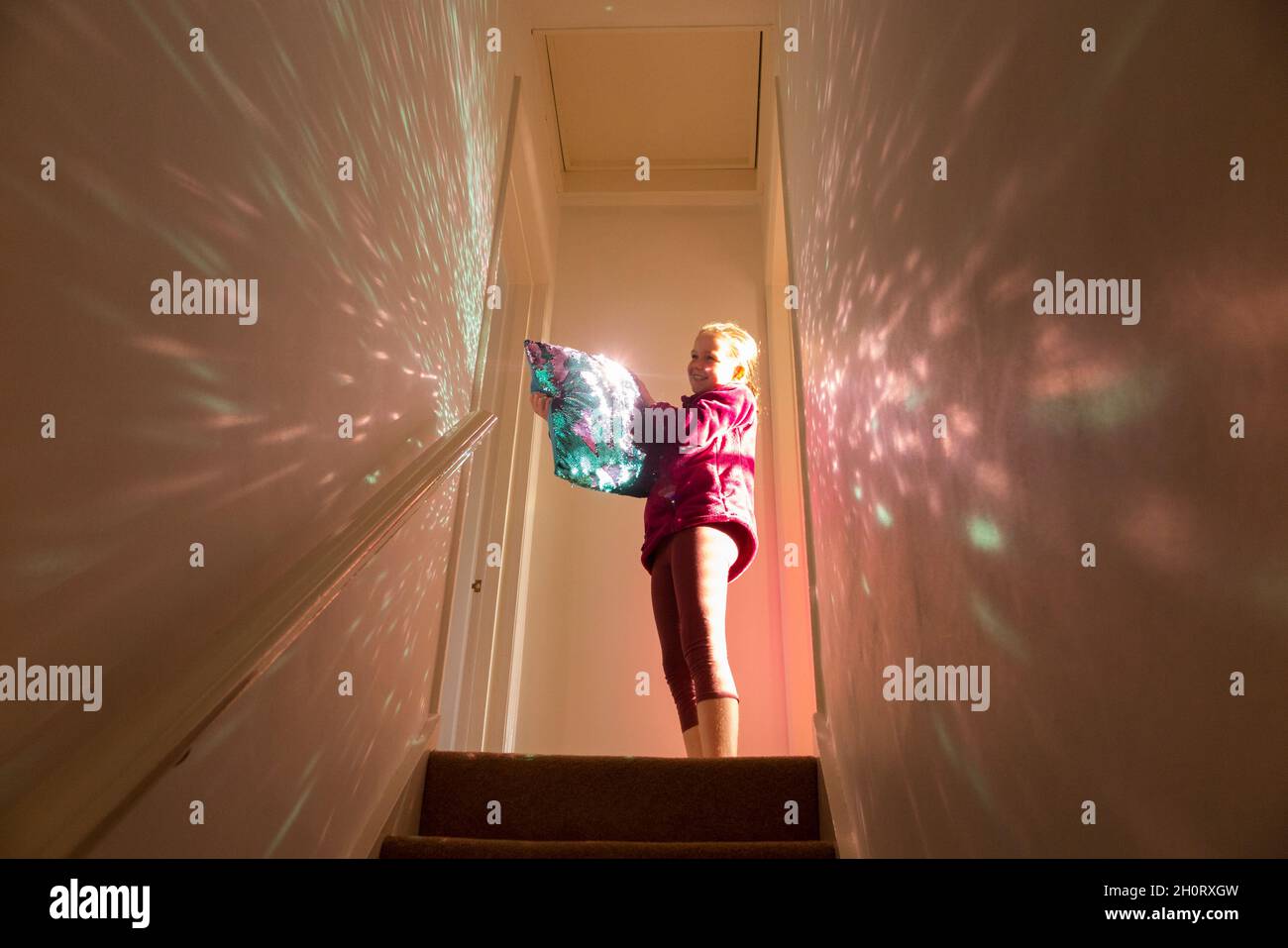 A nine year old girl child kid makes sparkly reflections with a ...