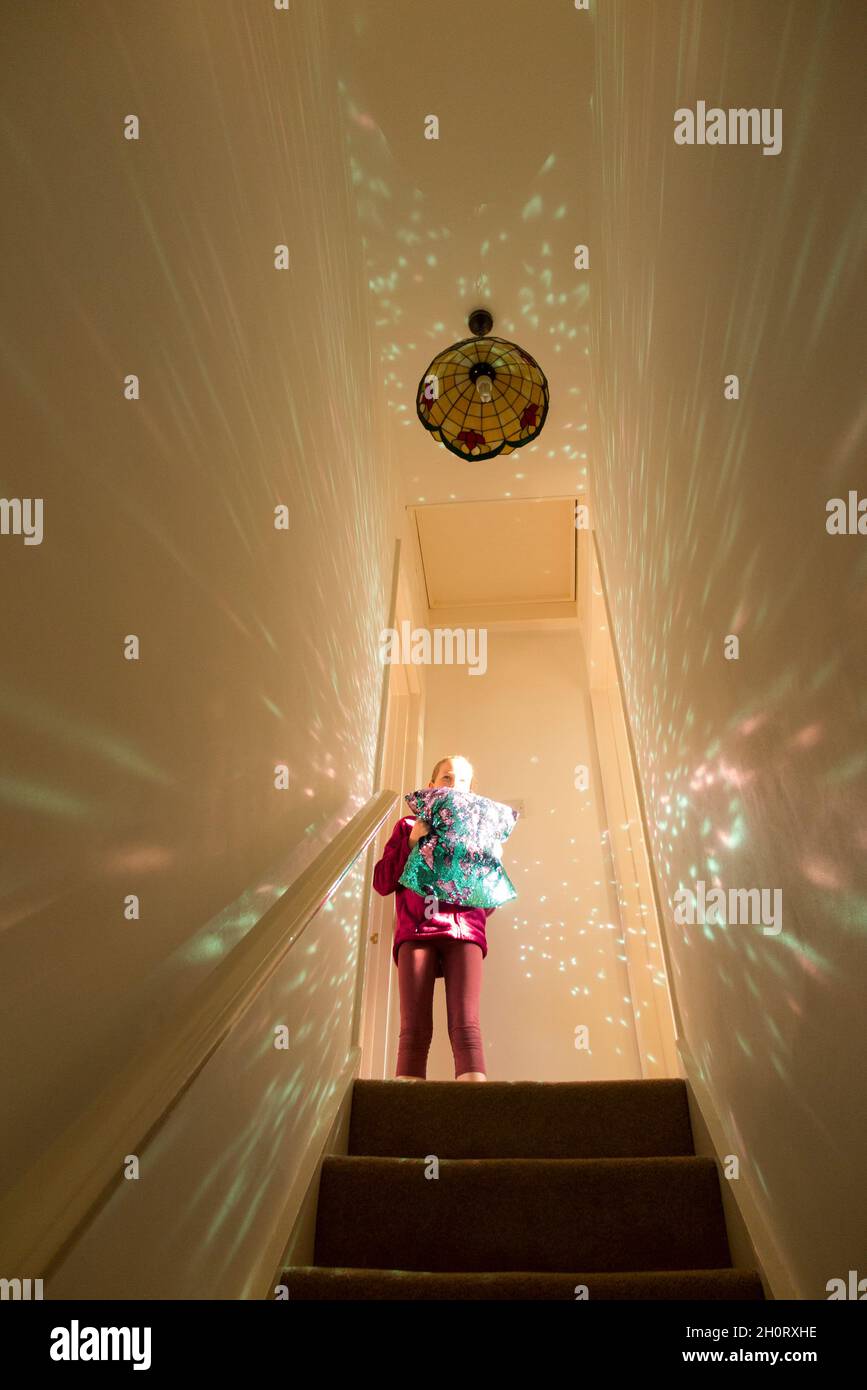 A nine year old girl child kid makes sparkly reflections with a ...