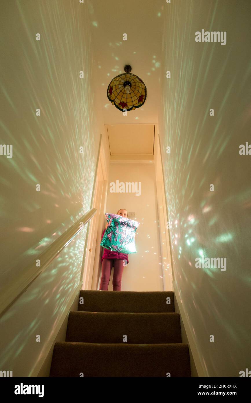 A nine year old girl child kid makes sparkly reflections with a ...