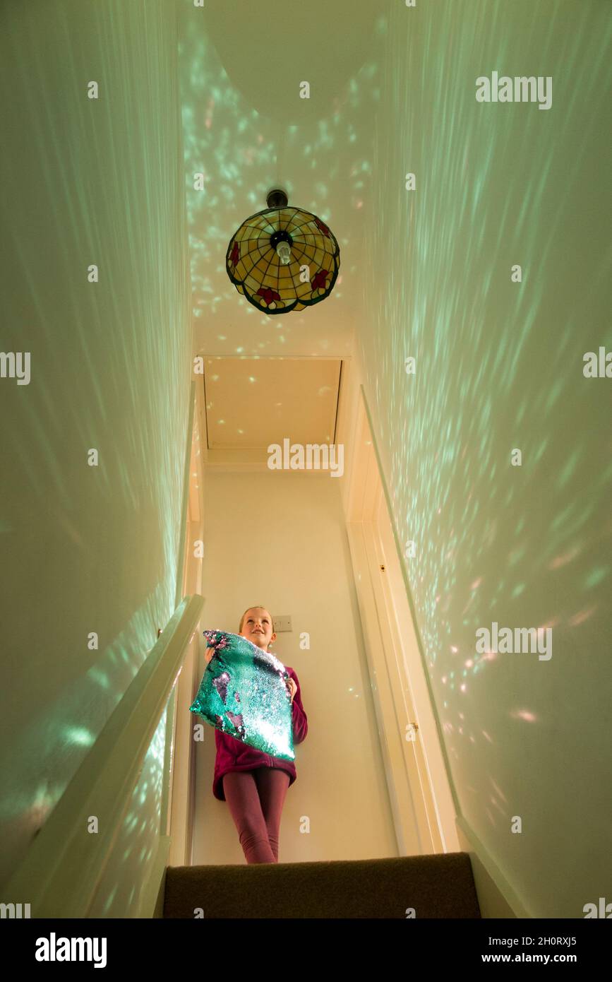 A nine year old girl child kid makes sparkly reflections with a ...