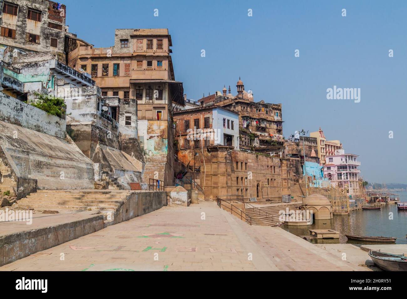 View of Ghats riverfront steps leading to the banks of the River Ganges ...