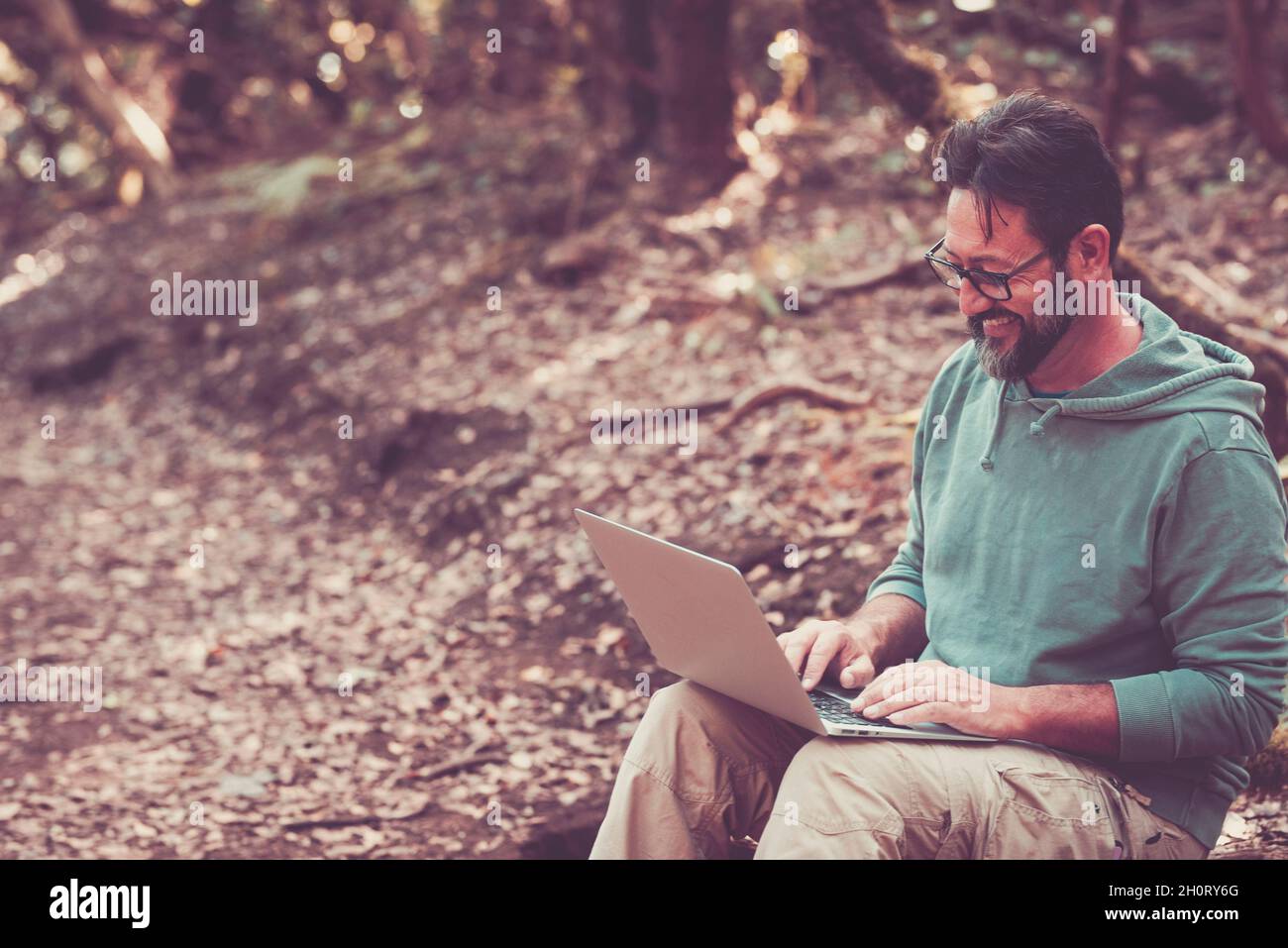 Adult mature man use laptop computer with roaming internet connection ...