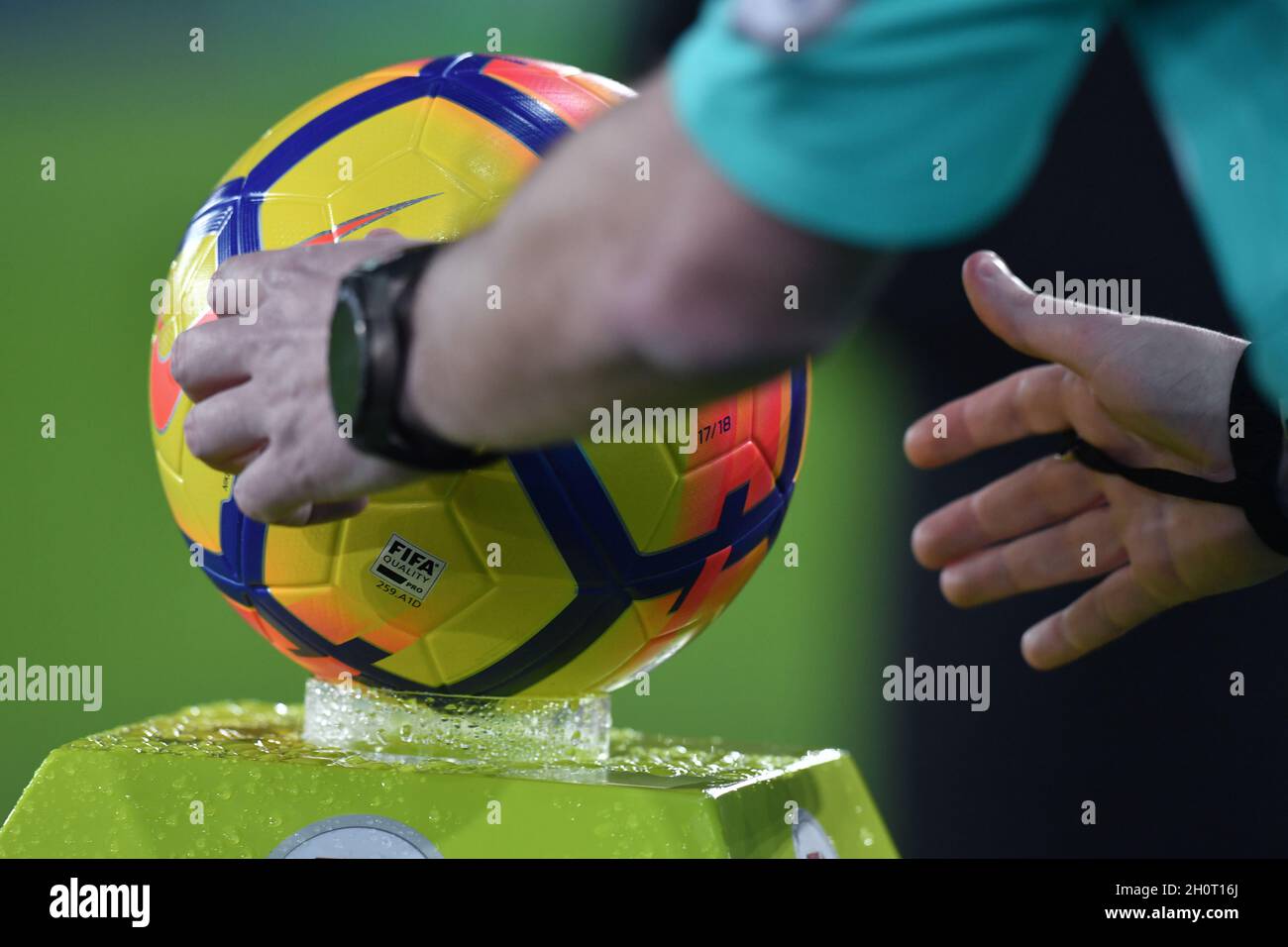 The referee picks up the match ball Stock Photo - Alamy