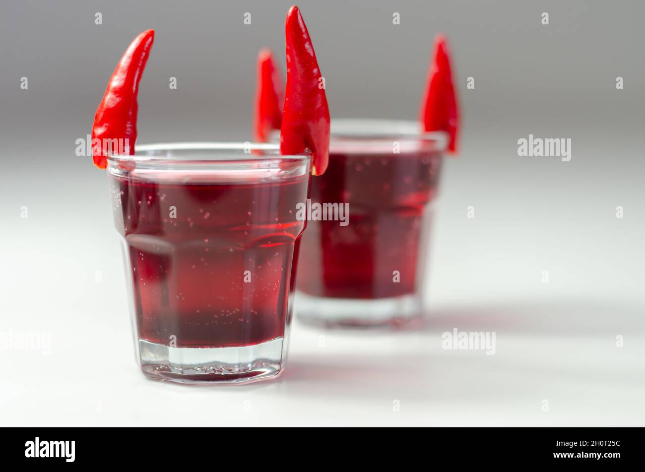 Drink shot prepared with vodka, grenadine and lemon juice decorated ...