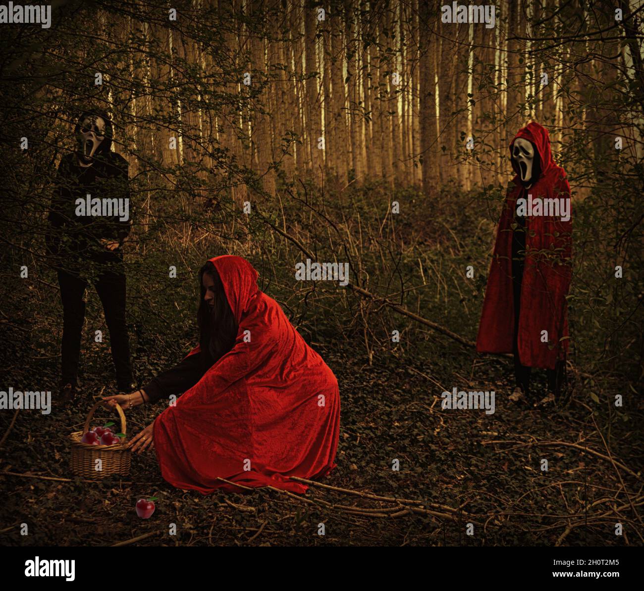 Little red riding Hood with masked person in black standing behind ...