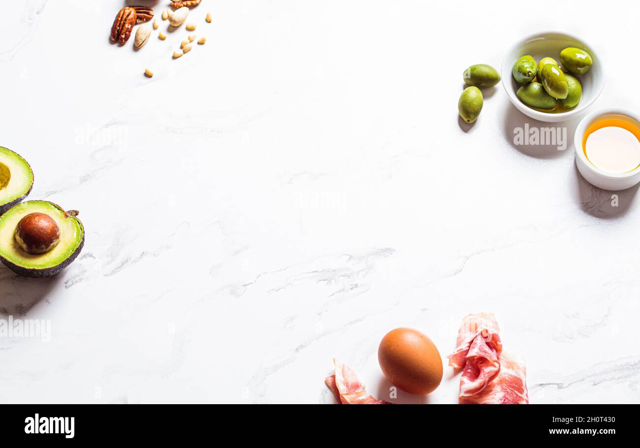 Keto diet ingredients frame on white marble background, copy space ...