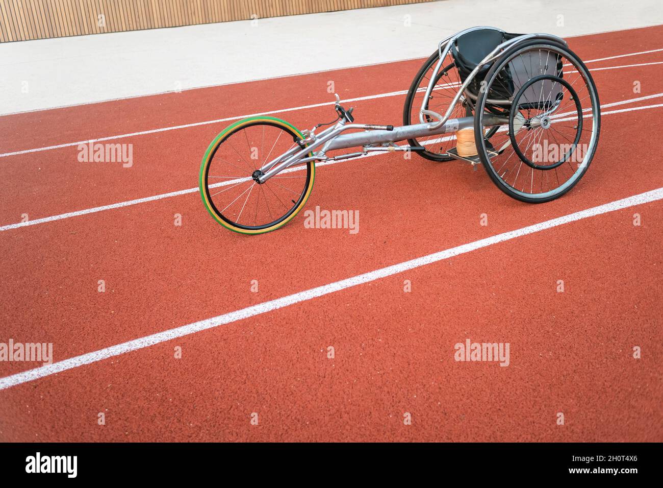 Athletic stadium track and a race wheelchair on it Stock Photo - Alamy